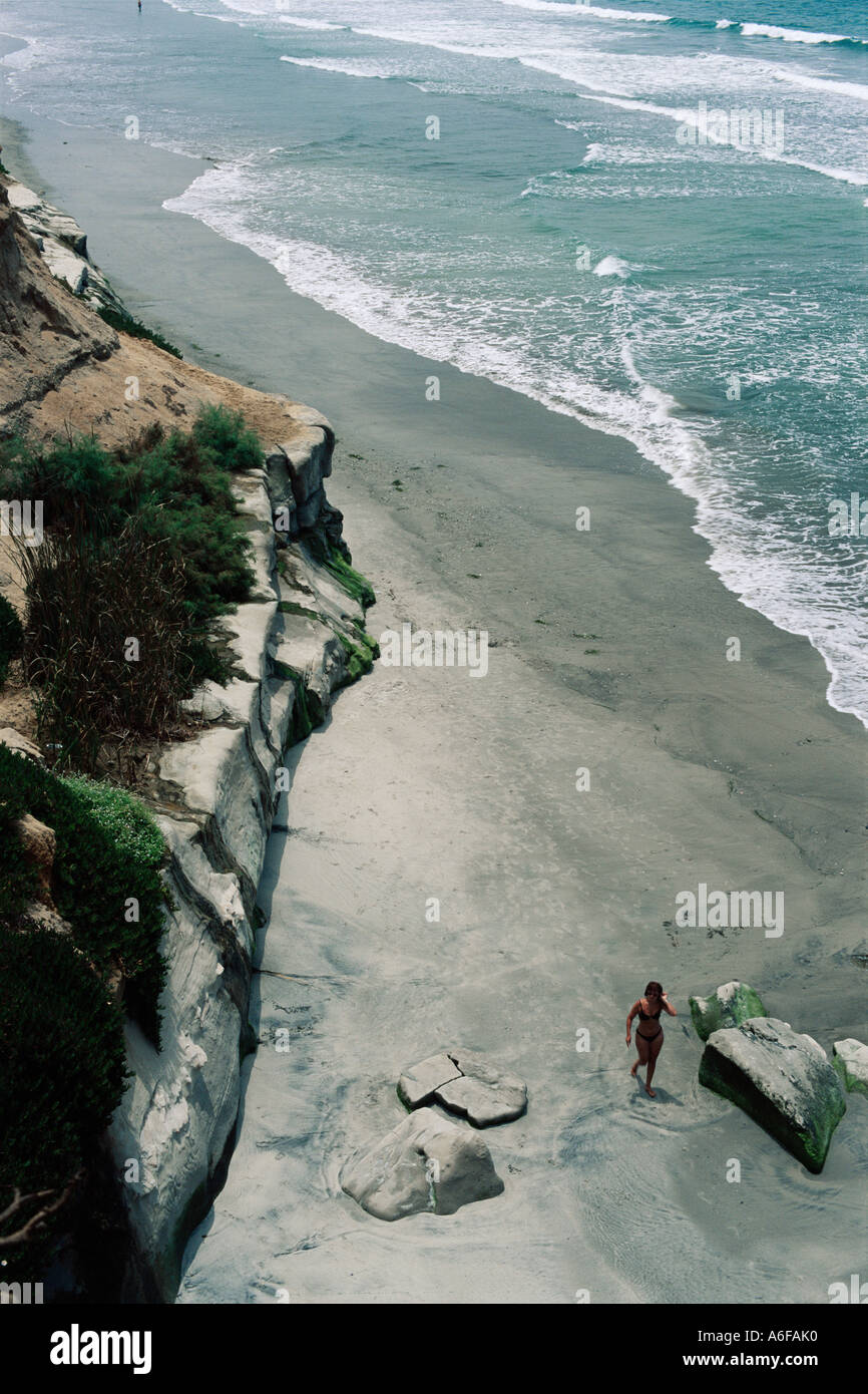 Woman in bikini swimsuit walks the beach, high view, Carlsbad ...