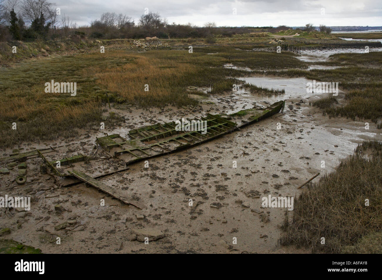 Old ship hull in the mud on the Saxon shoreline path, kent Stock Photo ...