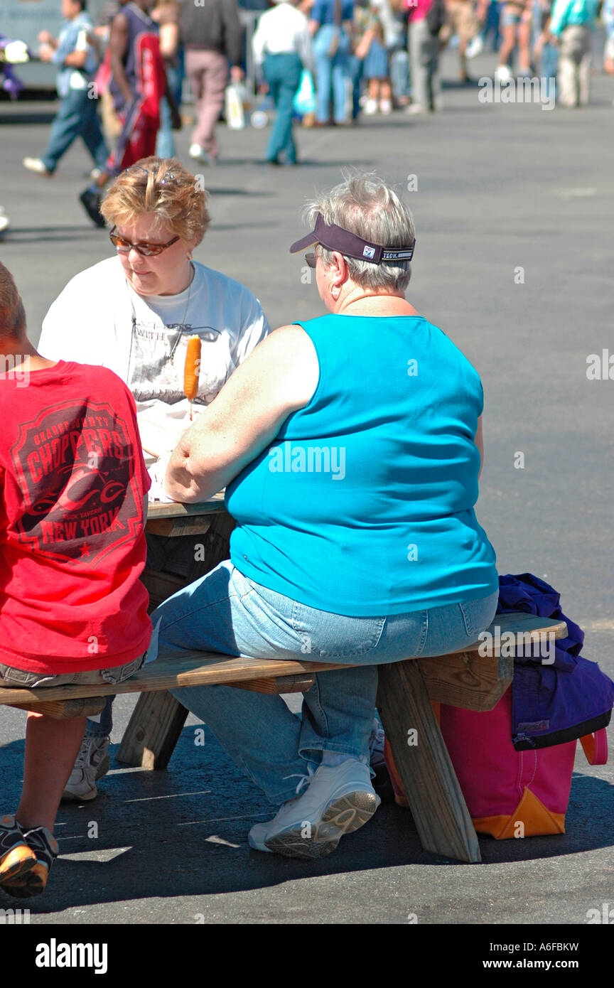 Very large heavy people eating fast junk food at Fair in the south ...