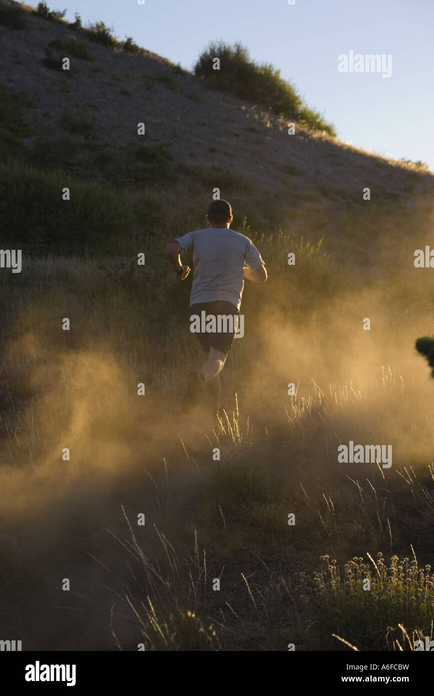 A man running in the dust in the Sierra mountains of California Stock ...