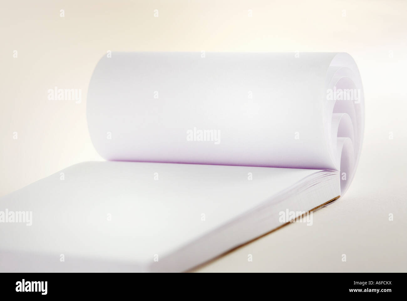 Low angle close up view of a notepad with pages folded back warm tone ...