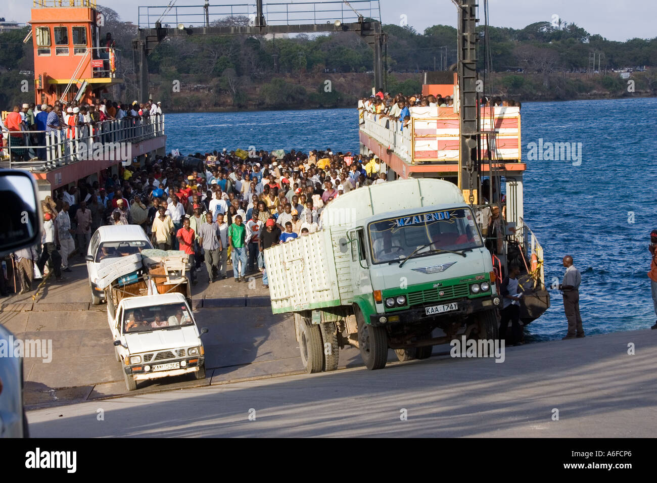 Vehicles and passengers disembarking from MV Kilindini at Likoni ...