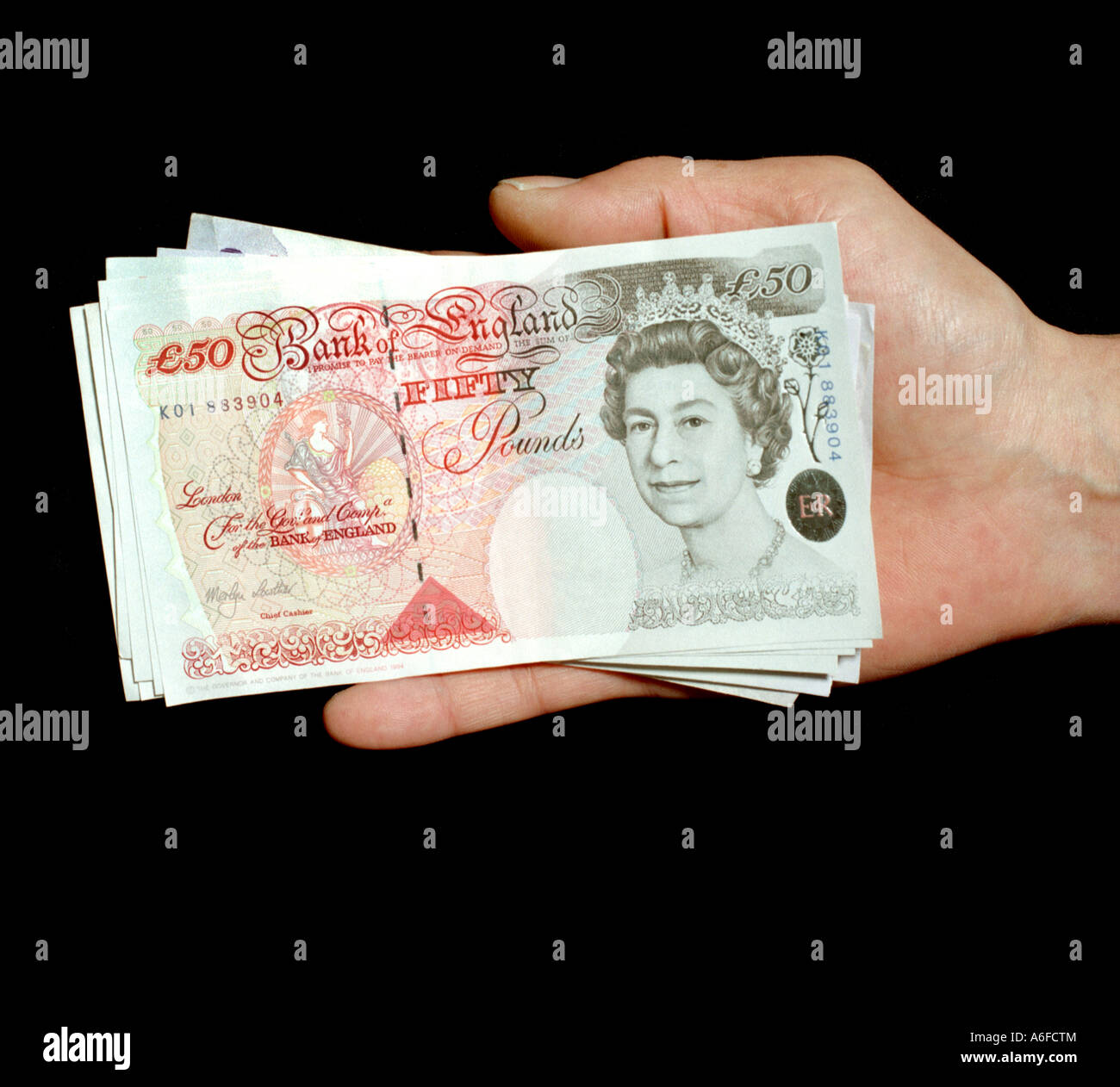 Hand holding British currency Stock Photo - Alamy
