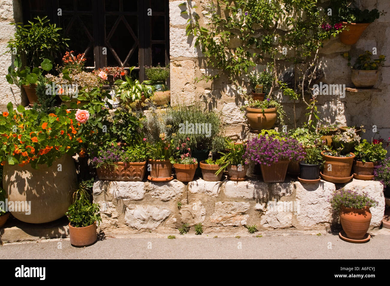 Medieval buildings and flowers in the town of Gourdon in Provence ...