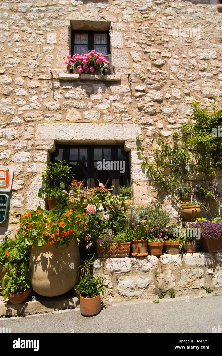 Medieval buildings and flowers in the town of Gourdon in Provence ...