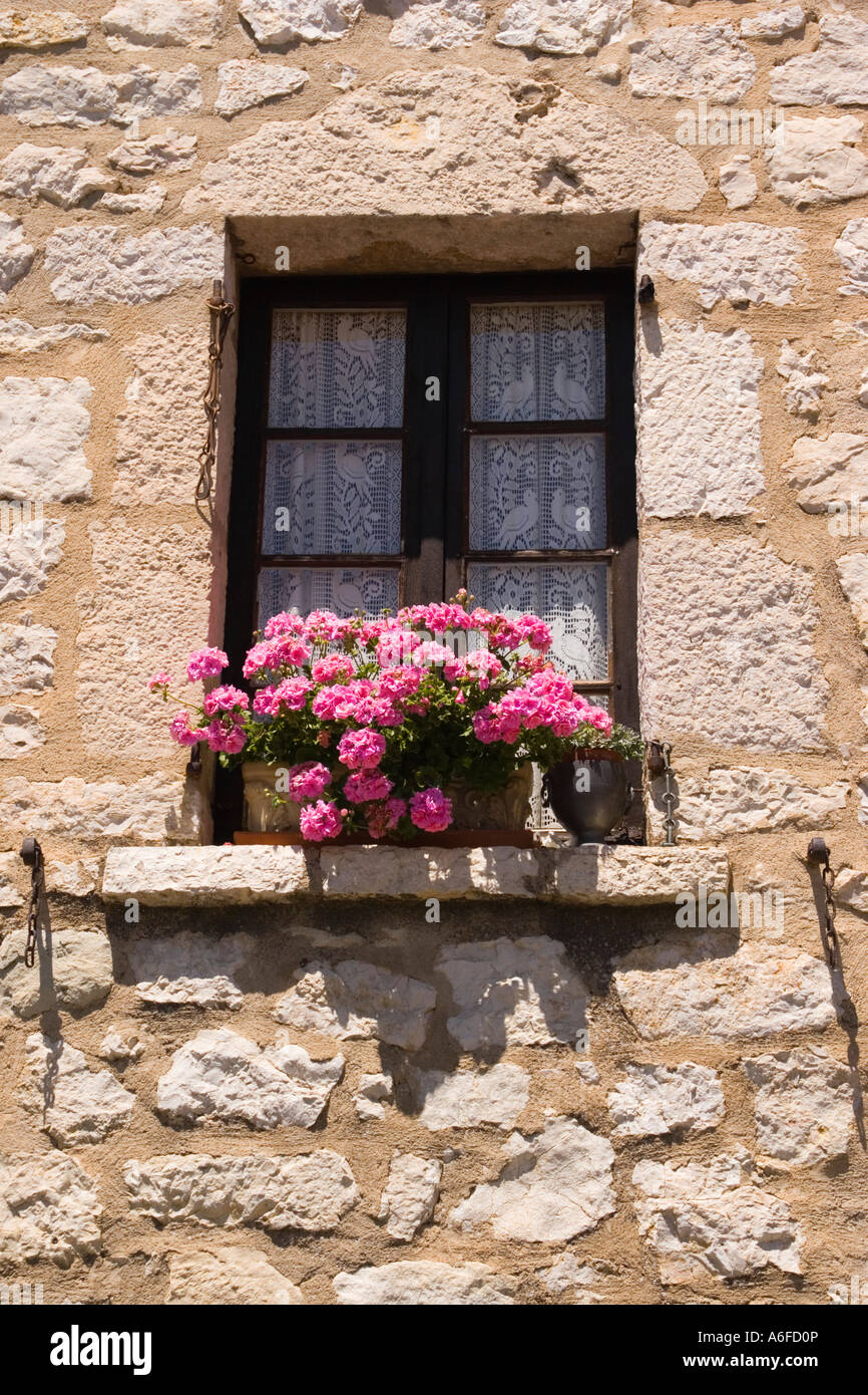Medieval buildings and flowers in the town of Gourdon in Provence ...