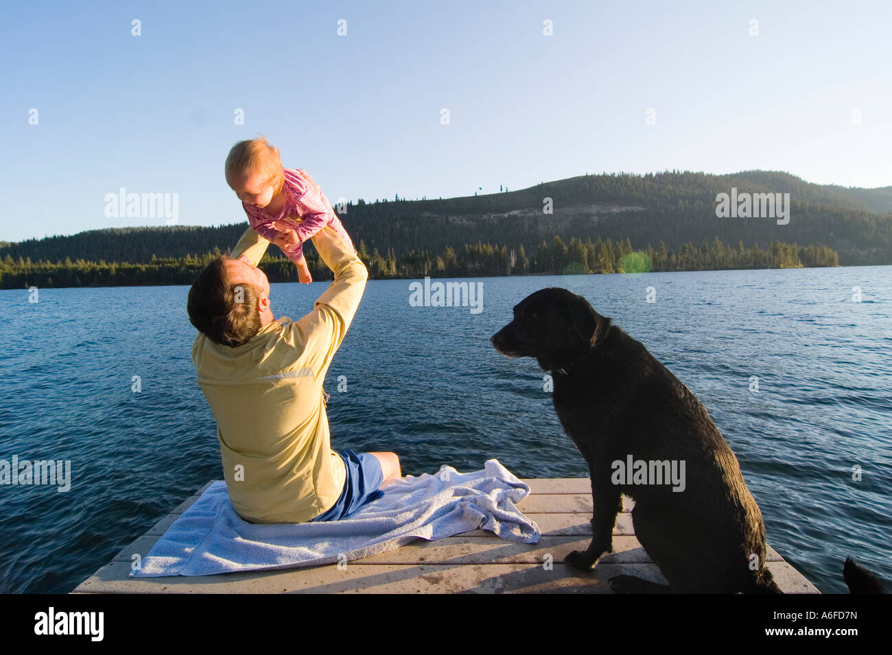 Kids sitting on dock hi-res stock photography and images - Alamy
