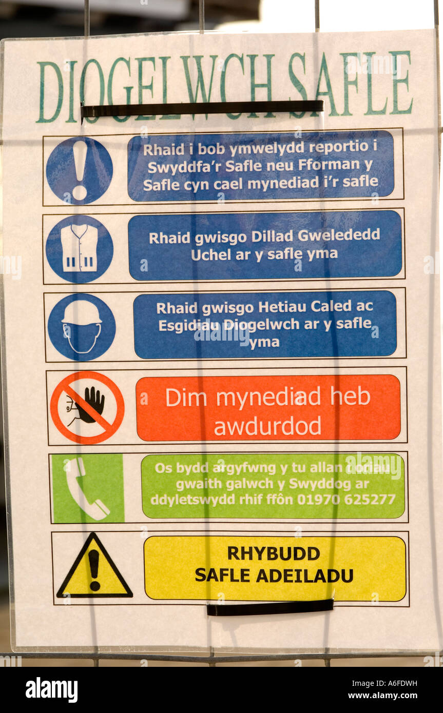 Construction building site safety warning sign on fence in welsh Wales ...