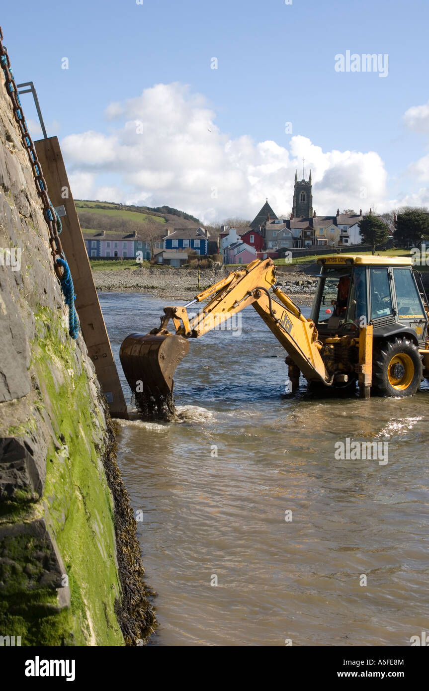 aberaeron ceredigion JCB digger repairing harbour wall at low tide ...
