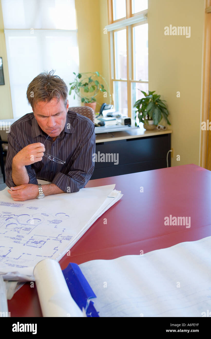Old man reading blueprints hi-res stock photography and images - Alamy