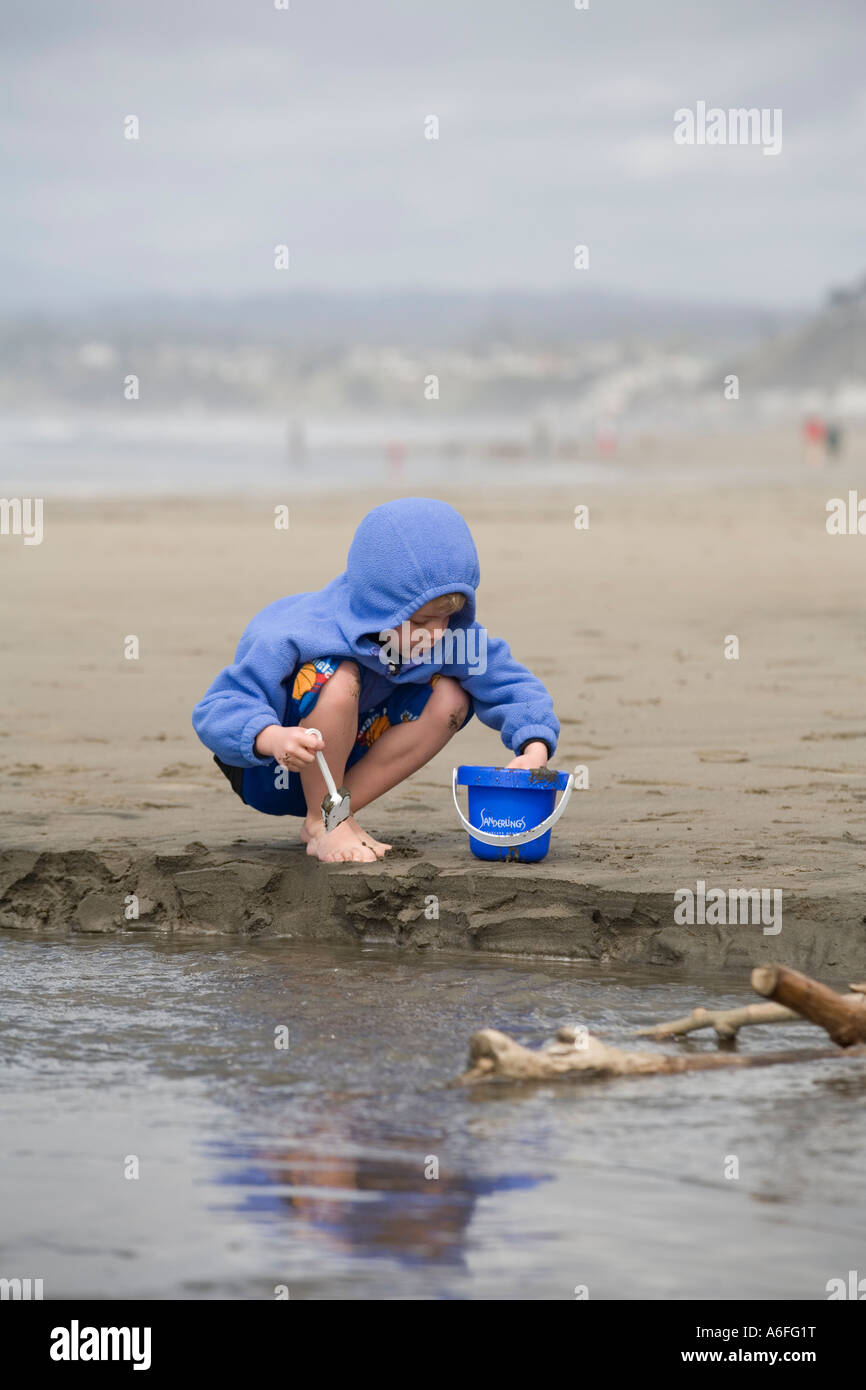 Boy Digging in the Sand on the beach Stock Photo - Alamy
