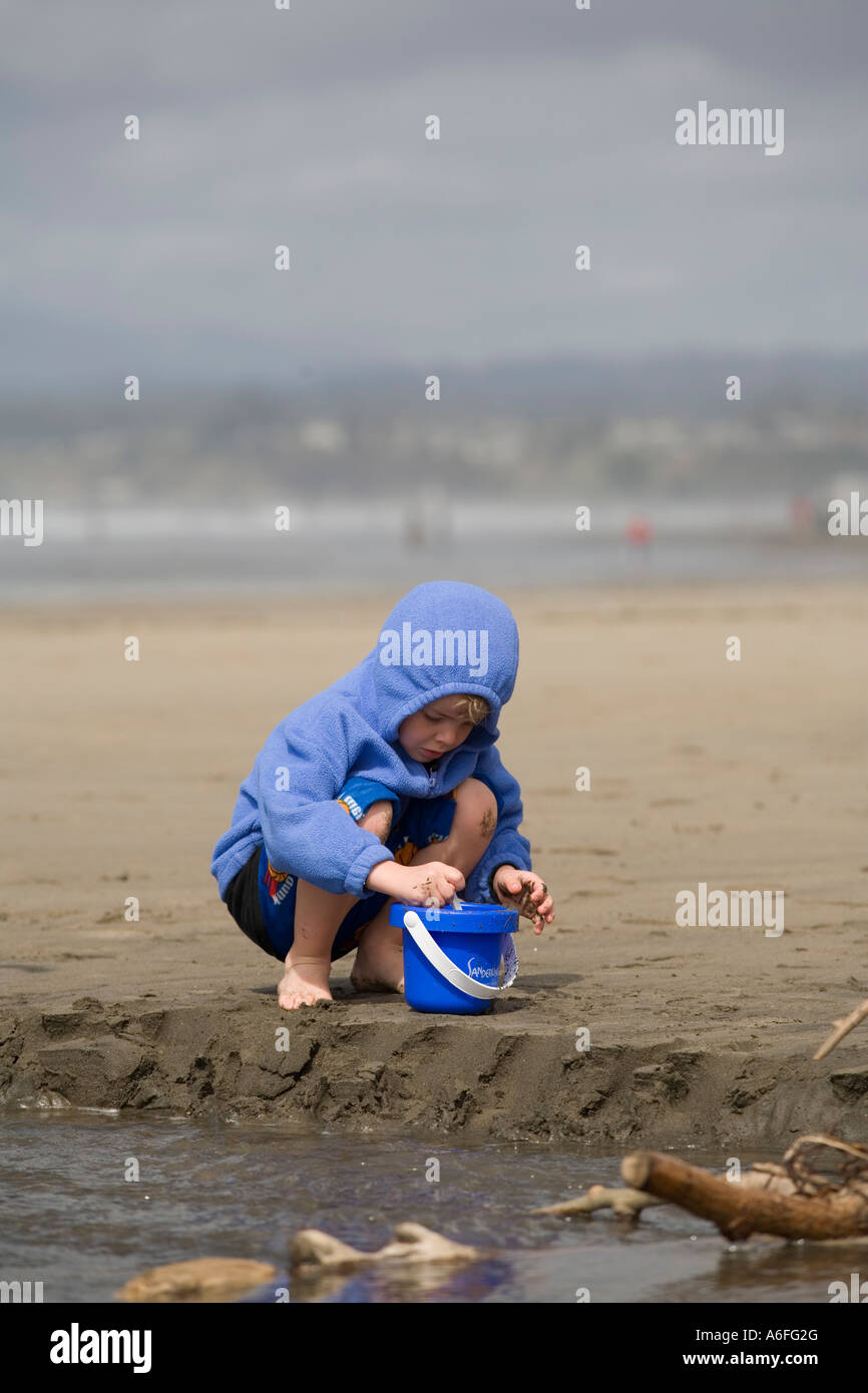Boy Digging in the Sand on the beach Stock Photo - Alamy