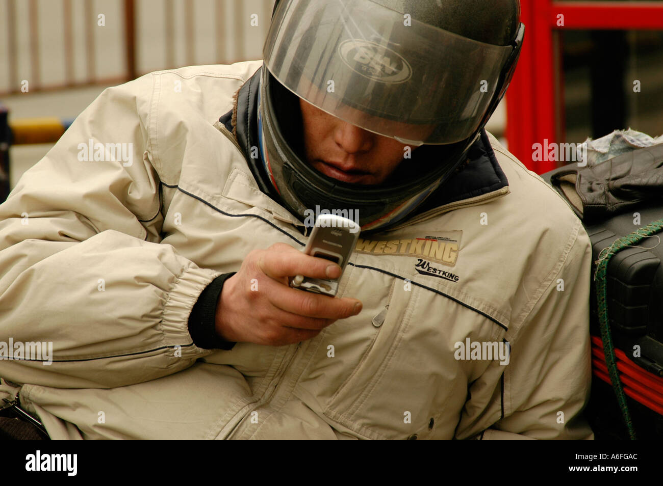 Motorcyclist using his mobile phone ubiquitous device in China Stock ...
