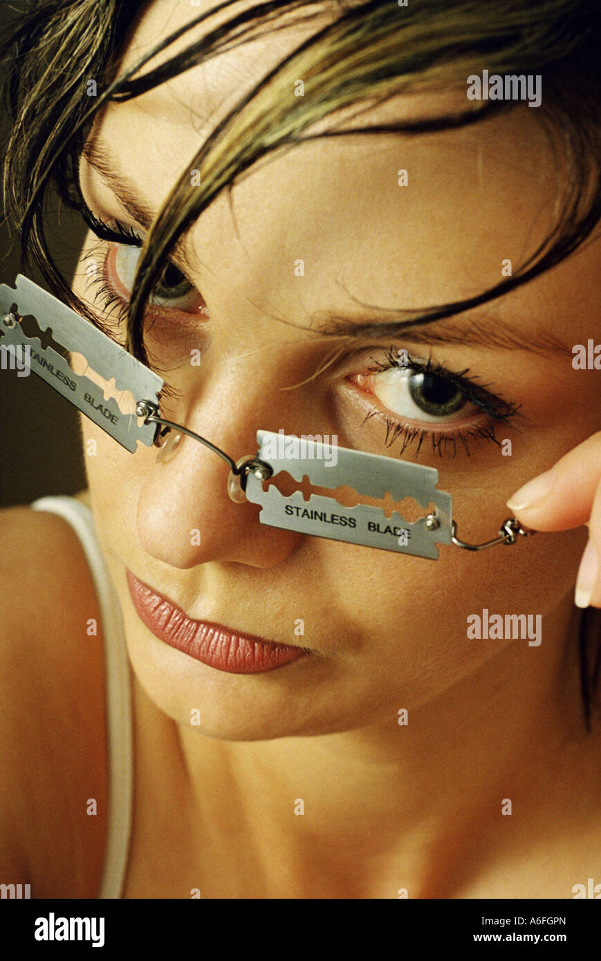 Woman with razors for eye glasses Danger sharp vision Stock Photo - Alamy