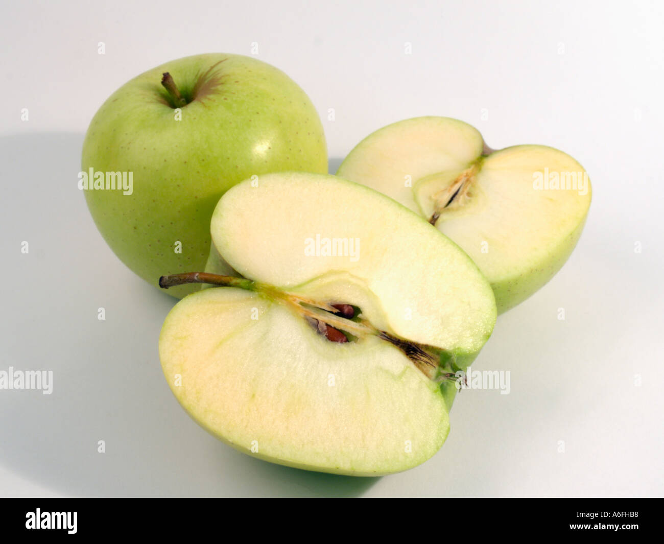 Golden delicious apple cut in half Stock Photo - Alamy