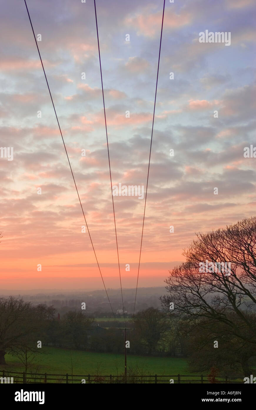 sunset over field telephone wires image Stock Photo - Alamy