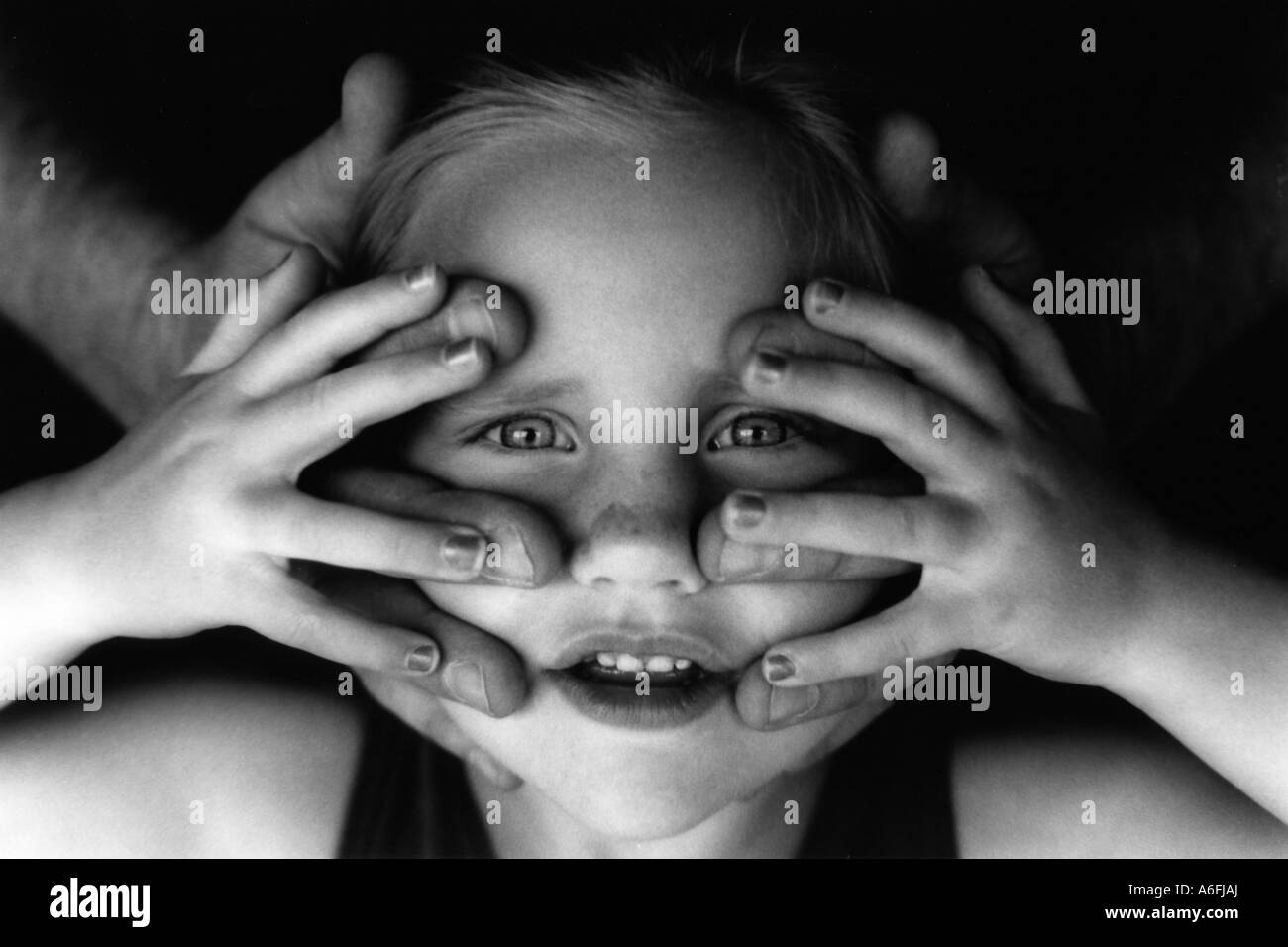 Girl with hands on face Stock Photo - Alamy
