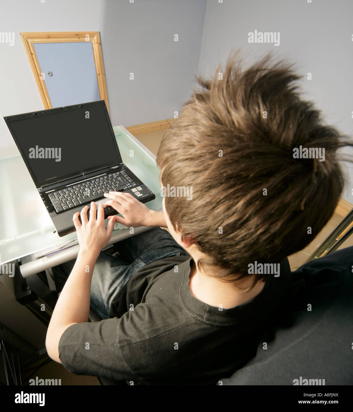 13 year old teenage boy using laptop computer Stock Photo - Alamy