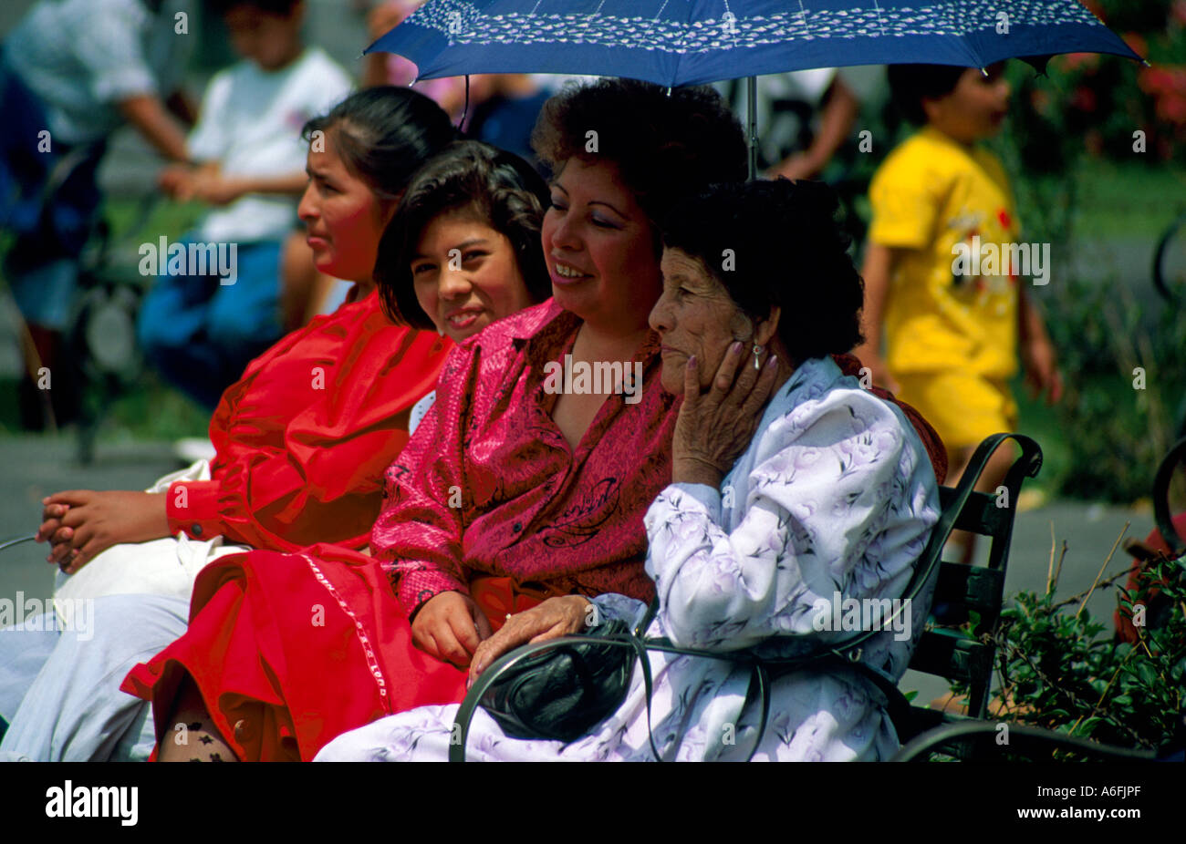 Well dressed women chatting on a bench with parasol in Arequipa Peru ...