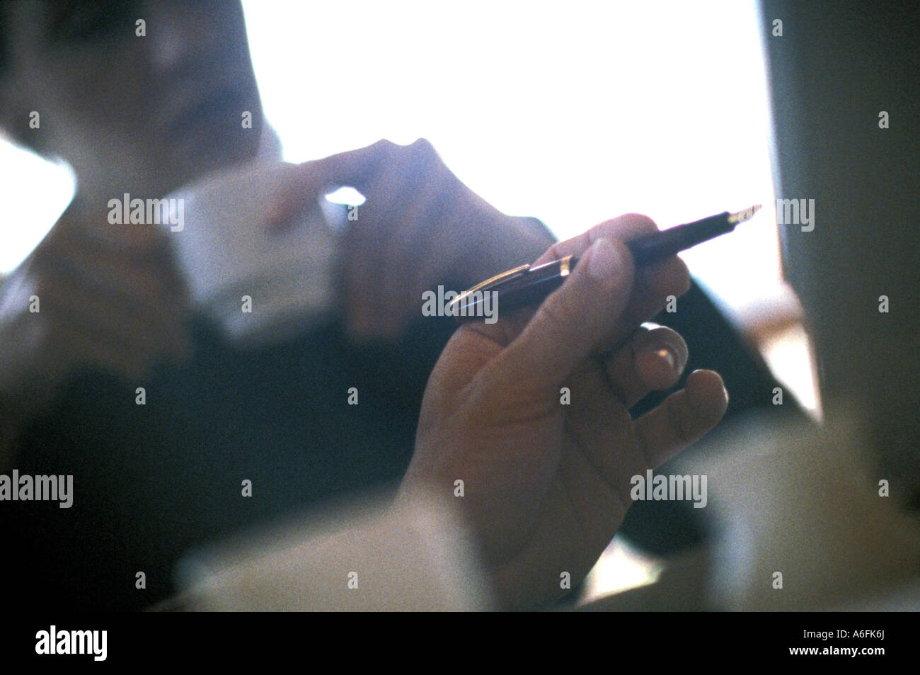 Pointing pen at computer screen in meeting Stock Photo - Alamy