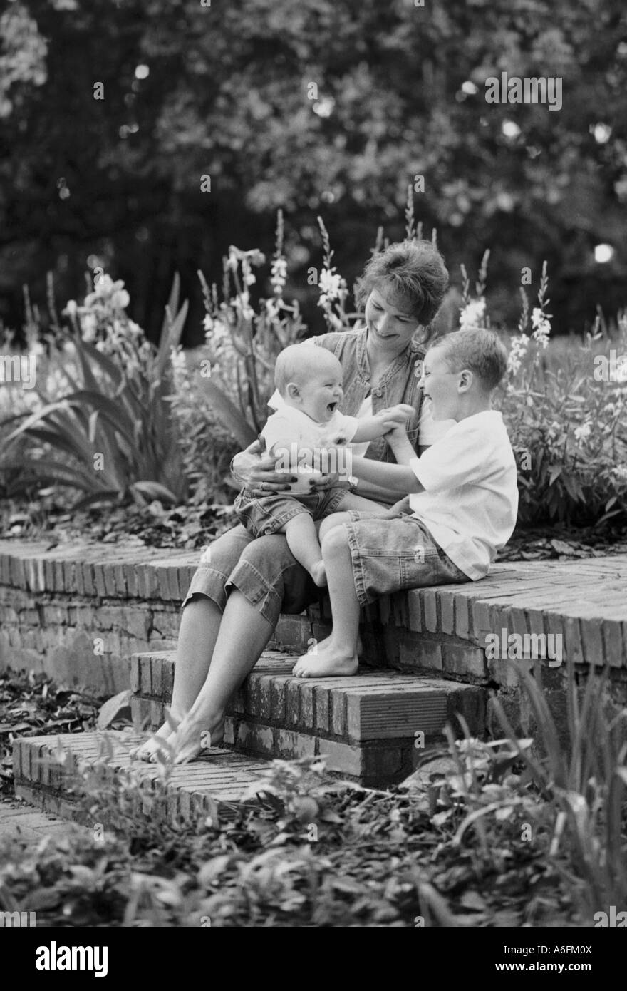 Mother child sitting in Black and White Stock Photos & Images - Alamy