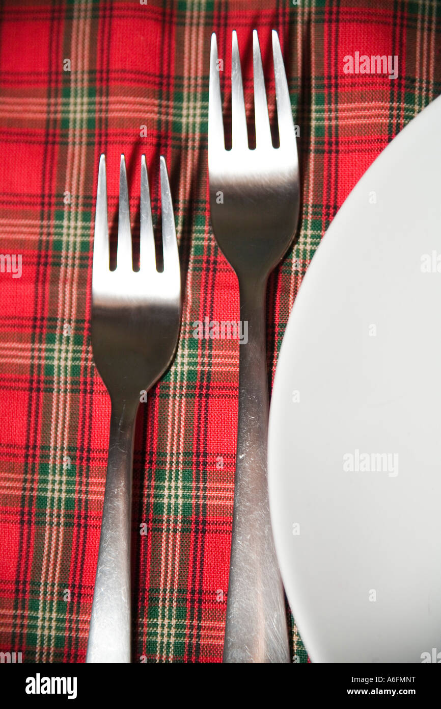 Holiday table setting forks and plate Stock Photo - Alamy