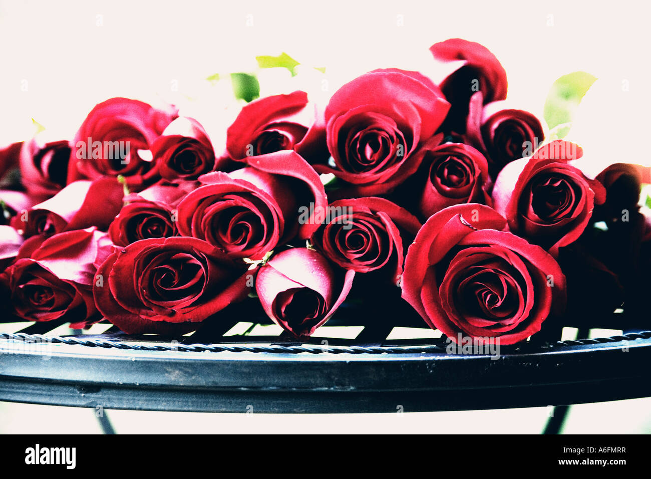 Red roses on bistro table Stock Photo - Alamy