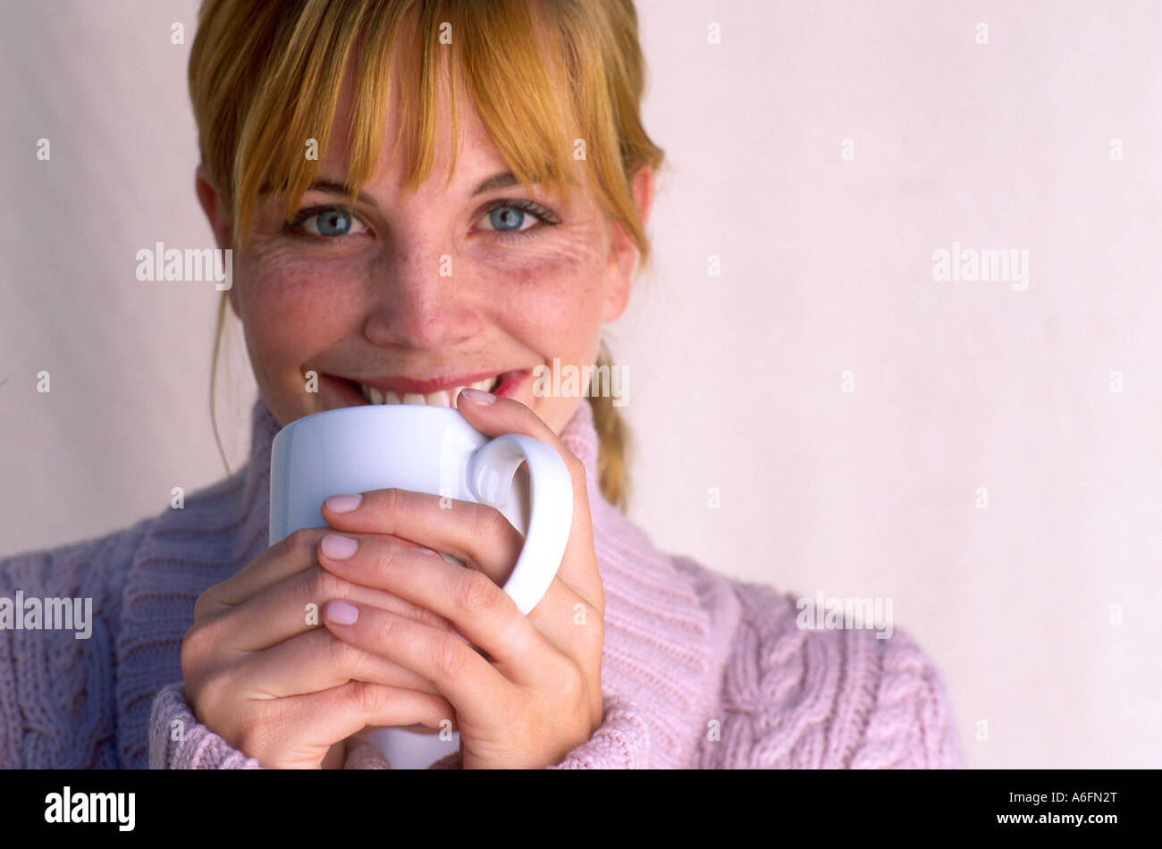 Laughing Young Woman Holds Cup High Resolution Stock Photography and ...