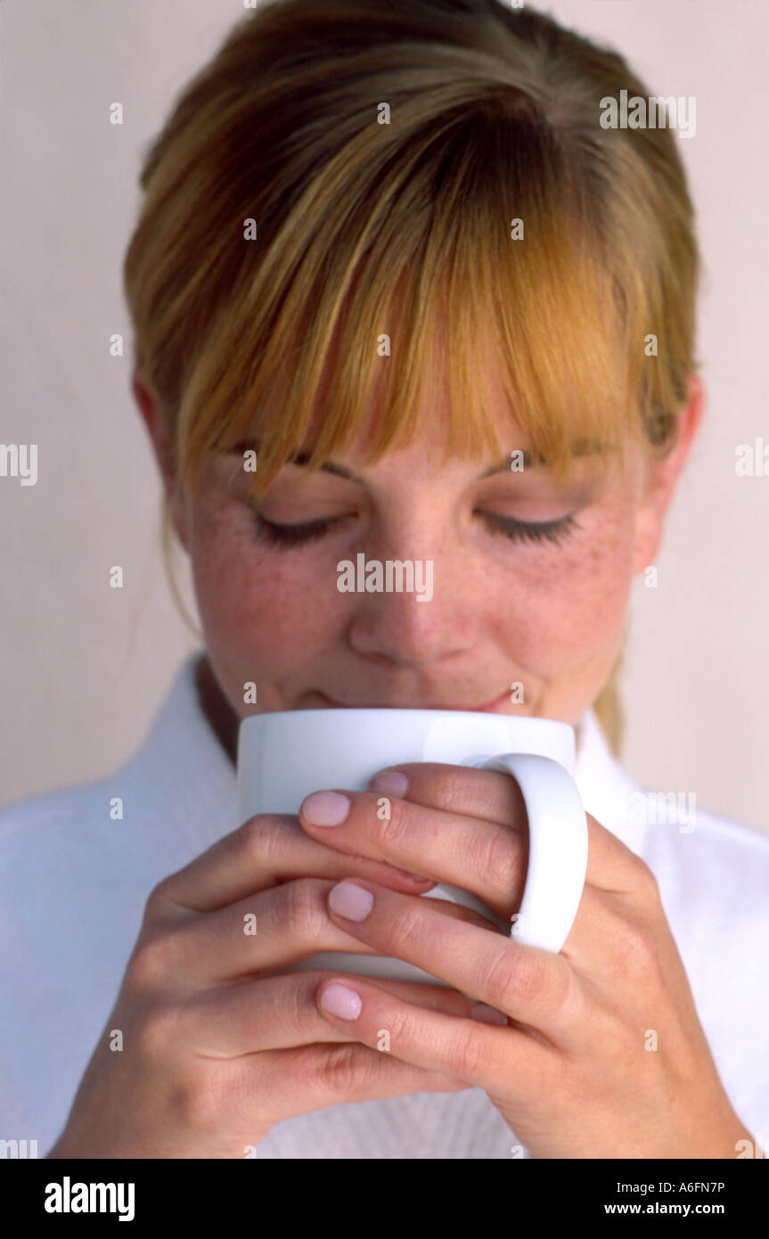 Woman enjoys drink from white hi-res stock photography and images - Alamy