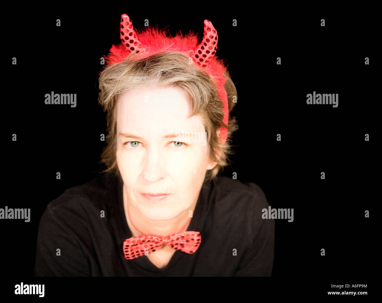Woman wearing devil horns Stock Photo - Alamy
