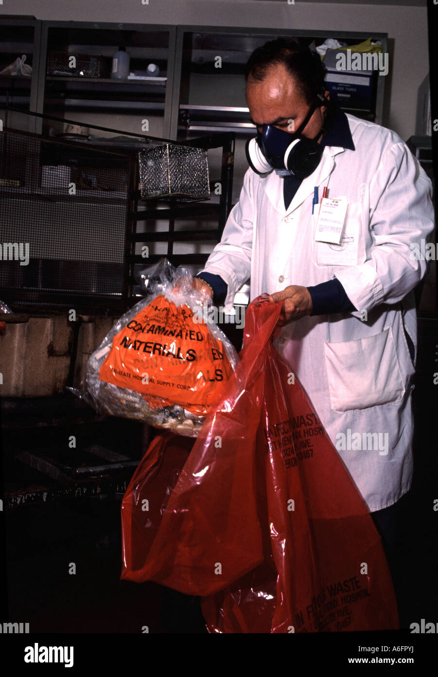 Hospital worker disposing of infectious waste MR NYC Stock Photo - Alamy