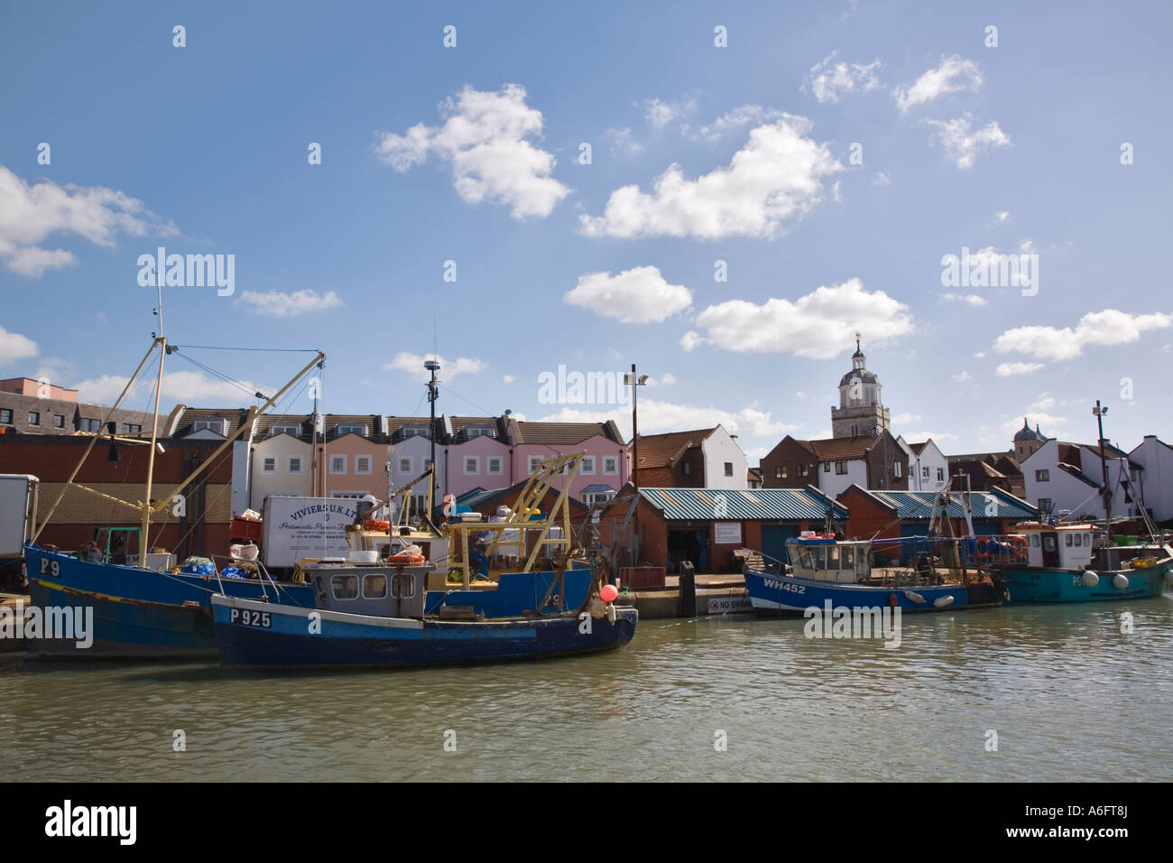 Town Camber fish docks with colourful fishing boats in water and modern ...