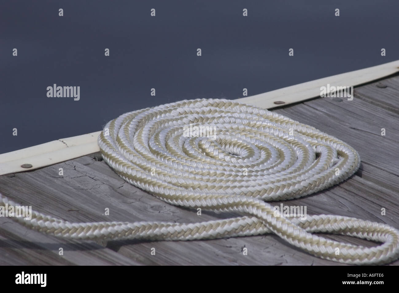rope coiled on dock Stock Photo - Alamy