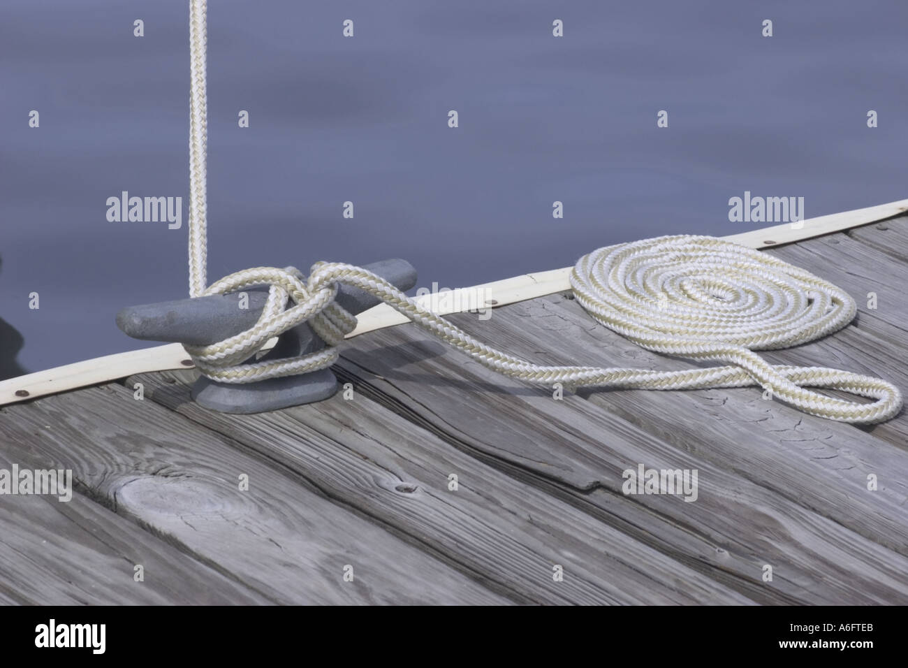 rope coiled on dock Stock Photo - Alamy