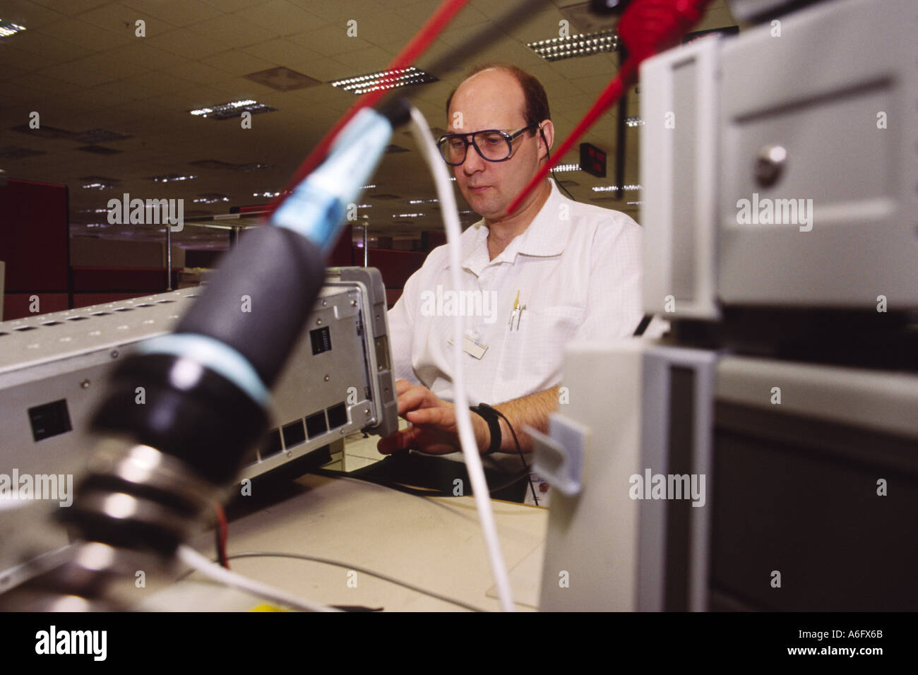 Man at work in electronics assembly factory Stock Photo - Alamy