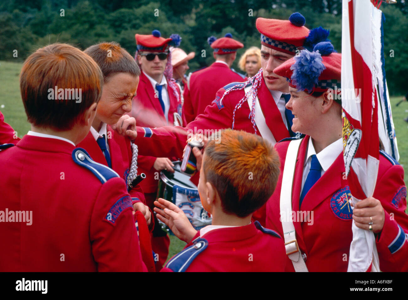Young loyalist band members paint each other's faces orange Stock Photo ...