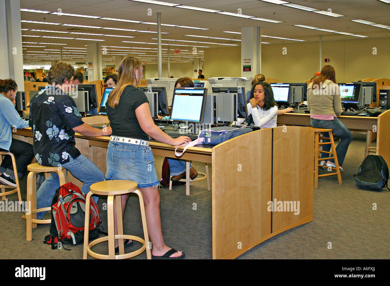 Ethnic students studying using reference computers in new library ...
