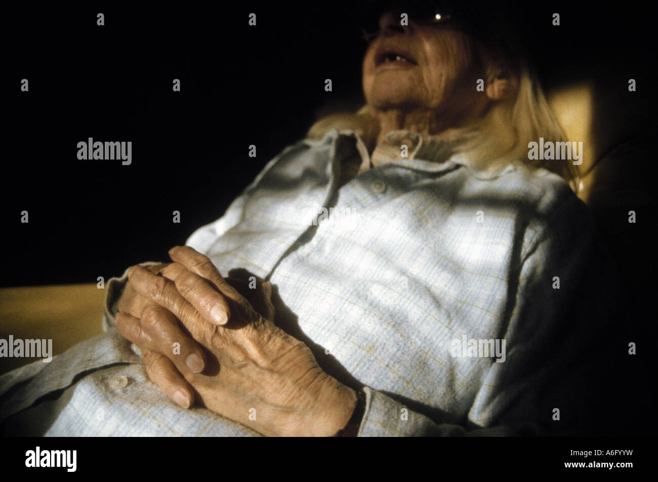 Elderly woman with hands folded on chest Stock Photo - Alamy