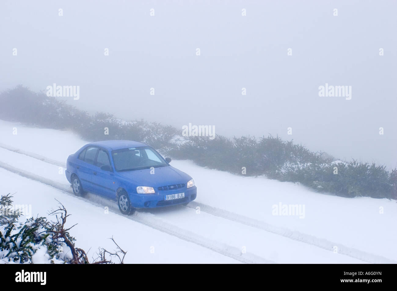 blue car driving through snow fog on Mount Roque de los Muchachos La ...