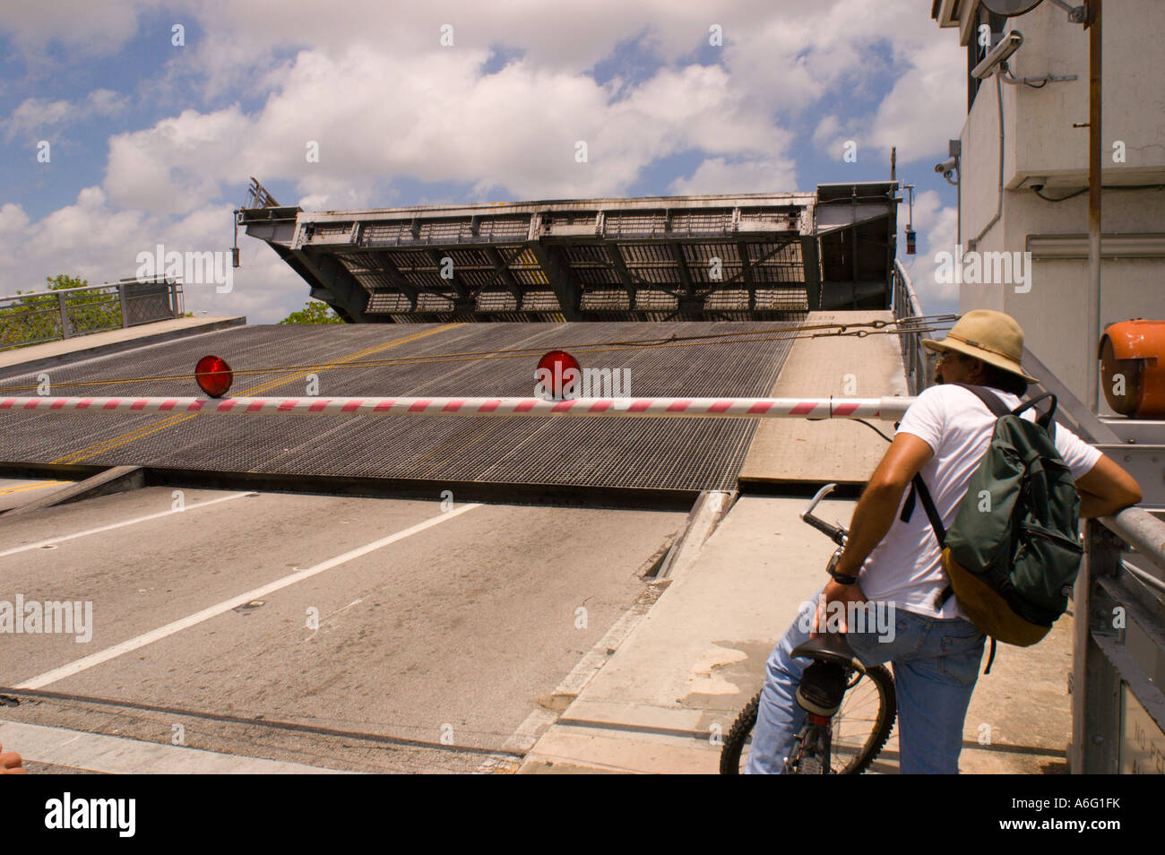 MIAMI FLORIDA USA Draw bridge opens over Miami RIver as man on bicycle ...