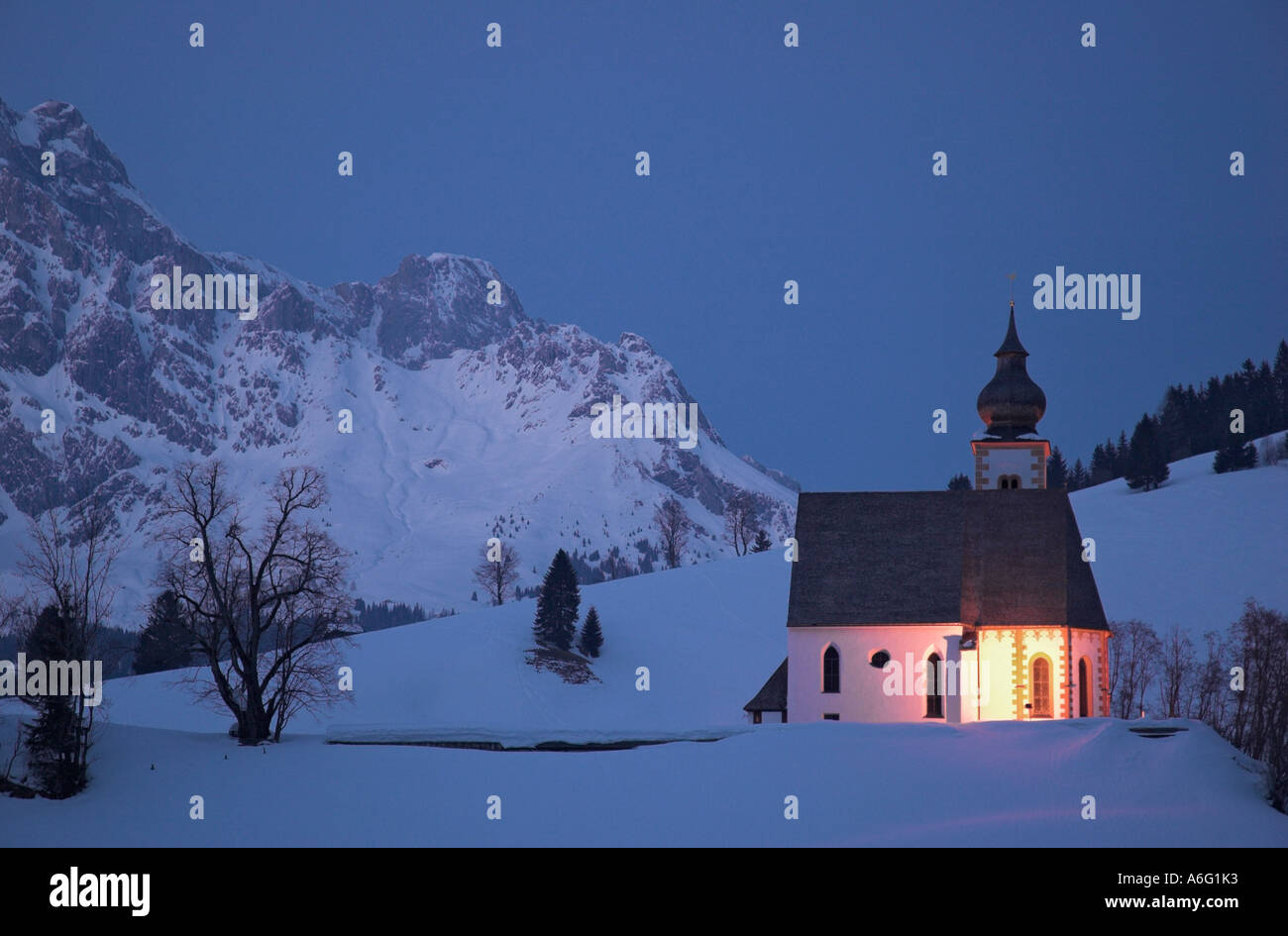 Illuminated church at dusk, Dienten, Salzburger Land, Austria Stock ...