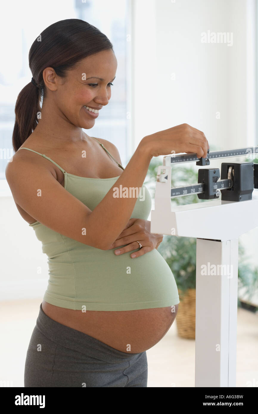 Pregnant African woman on scale Stock Photo - Alamy