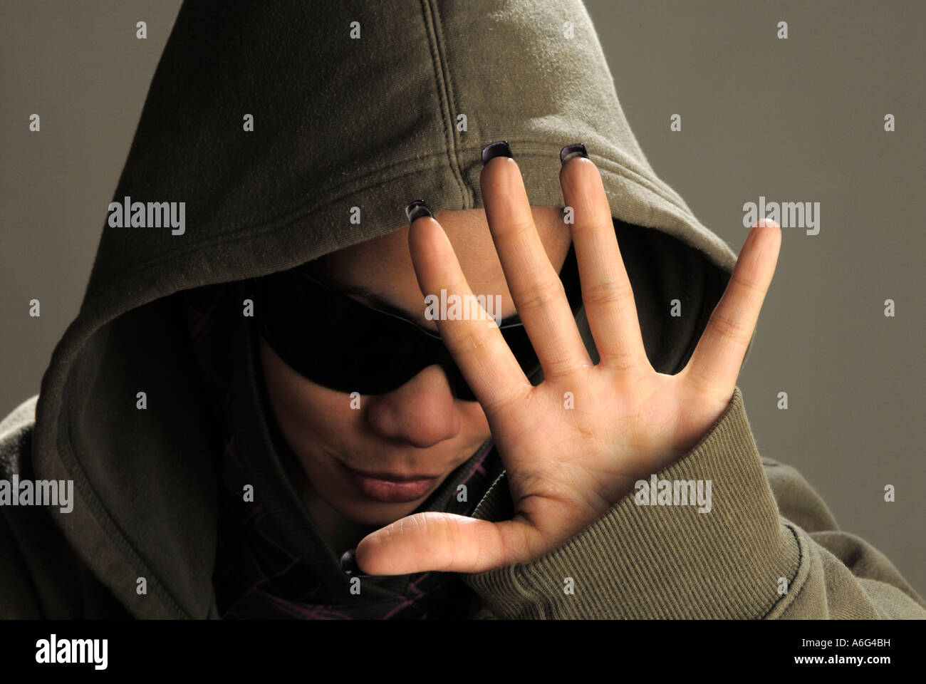 Portrait, Woman hiding behind hand Stock Photo - Alamy