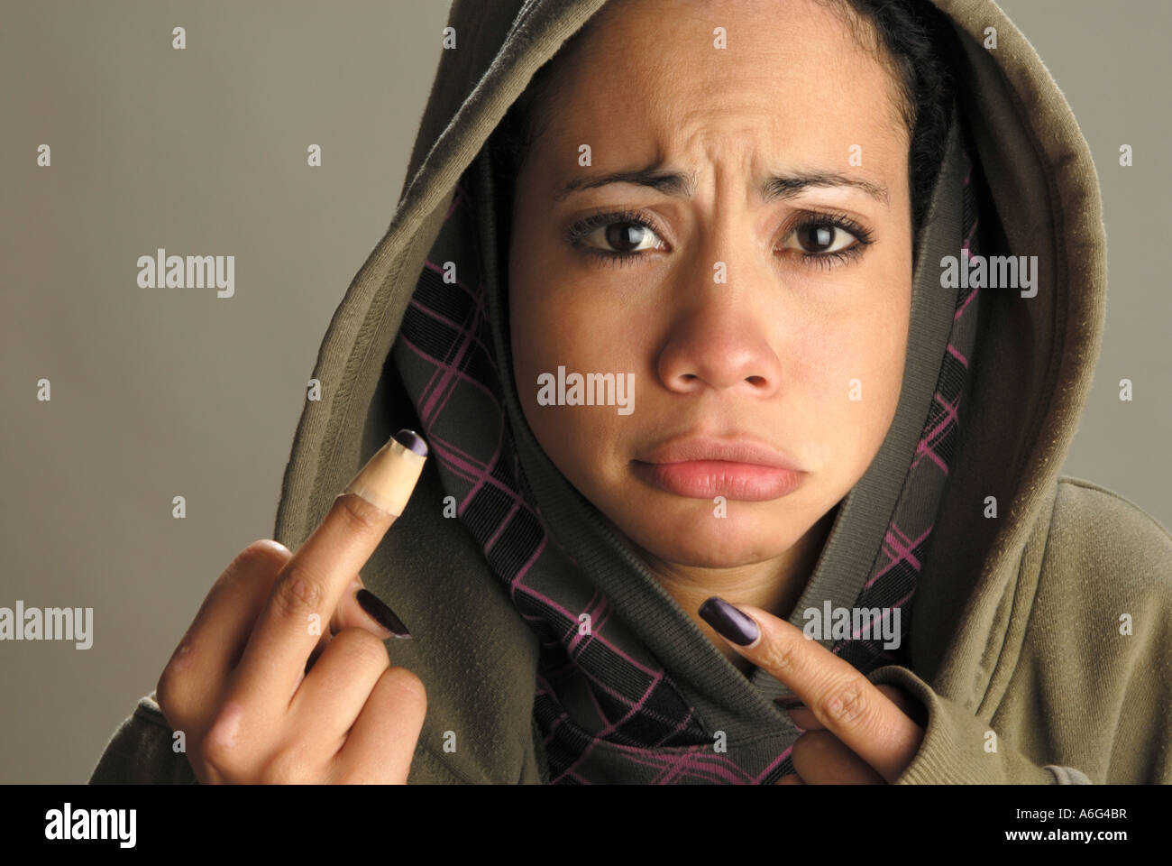 Portrait, Woman showing wounded finger Stock Photo - Alamy