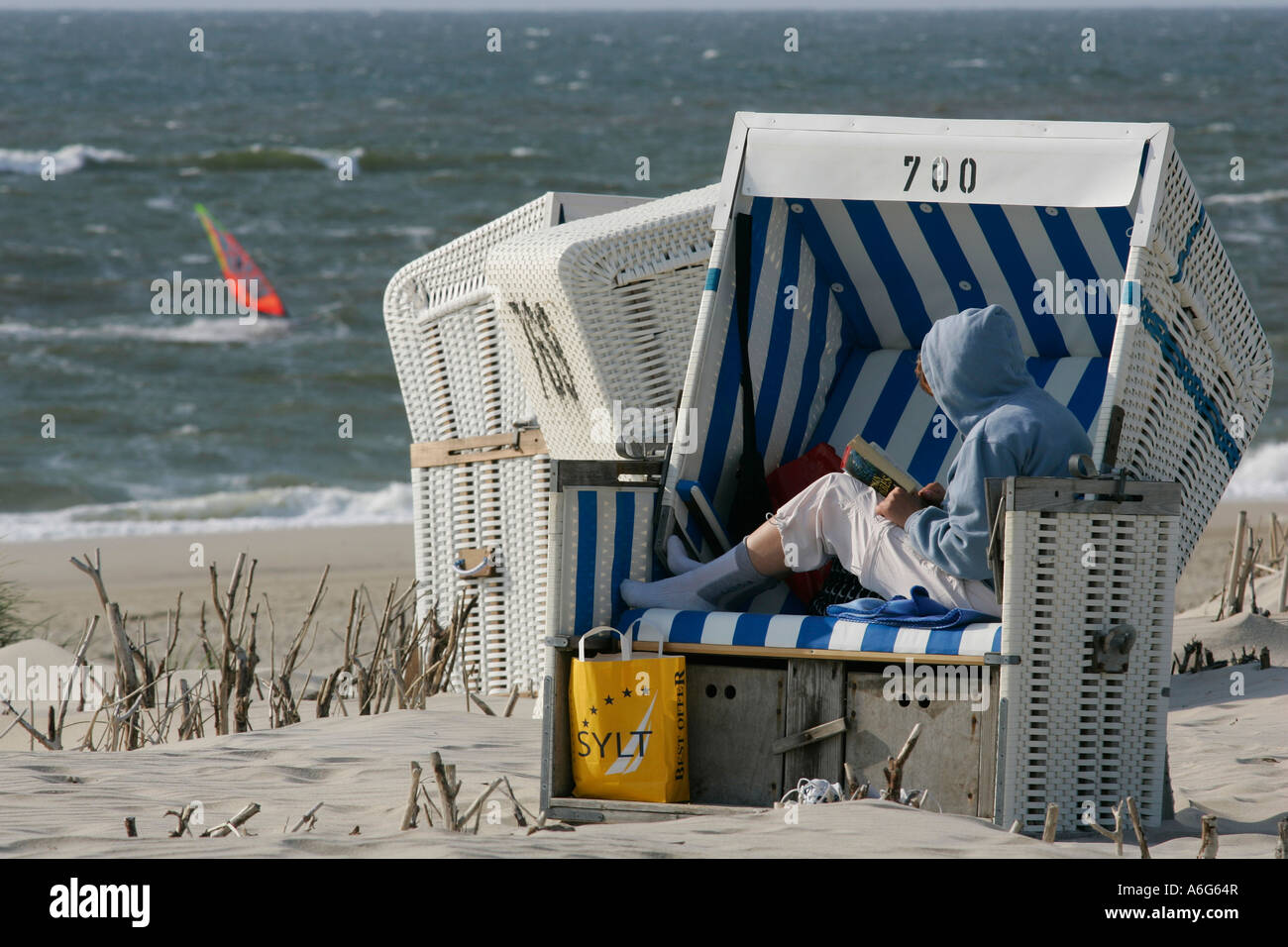 Woman reading in beach chair, beach near Westerland, Sylt, Schleswig ...