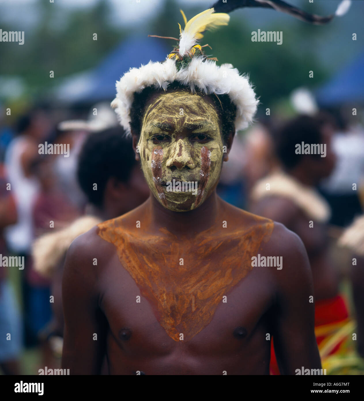 Portrait of young Papua New Guinea male tribesman body and face painted ...
