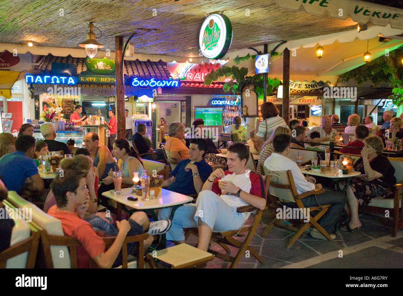 Outside bar taverna restaurant at night in Benitses Corfu Island Greece ...
