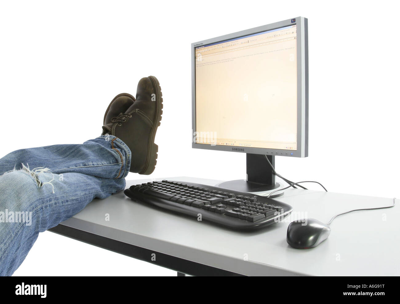 computer workstation with shoes on the writing desk during a break ...