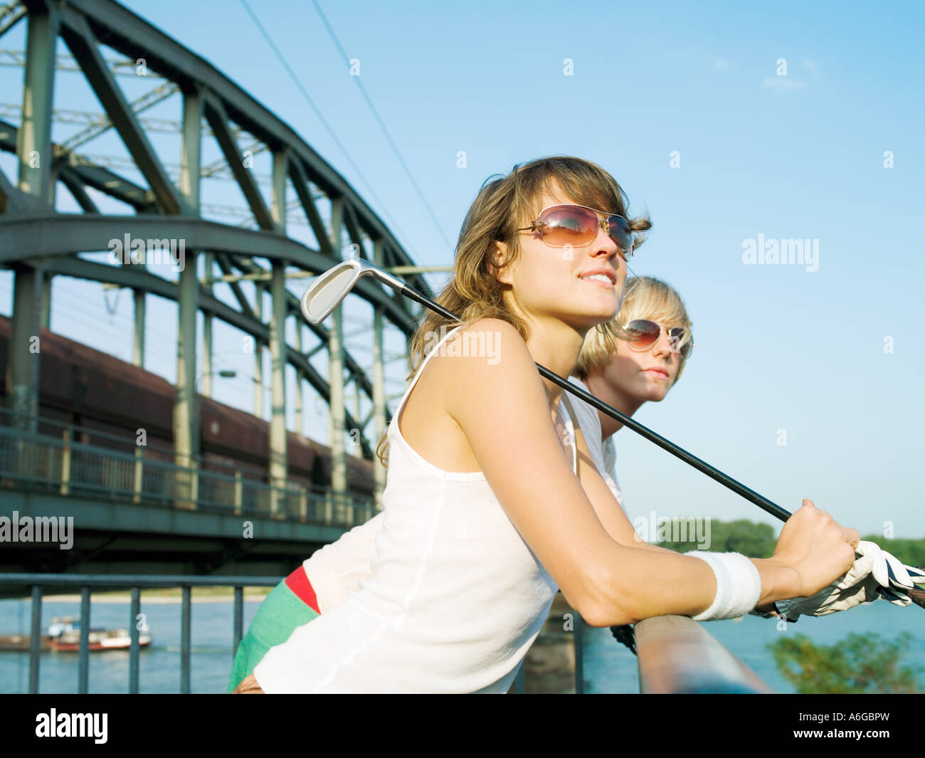 Female golfers by a bridge Stock Photo - Alamy