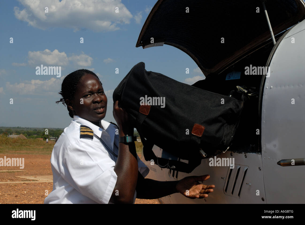 Flying Kampala to Kitgum.Female pilot loading baggage Stock Photo - Alamy